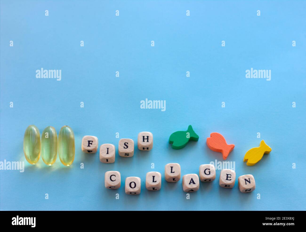 Fish collagen concept. Collagen capsules and fishes on blue background ...