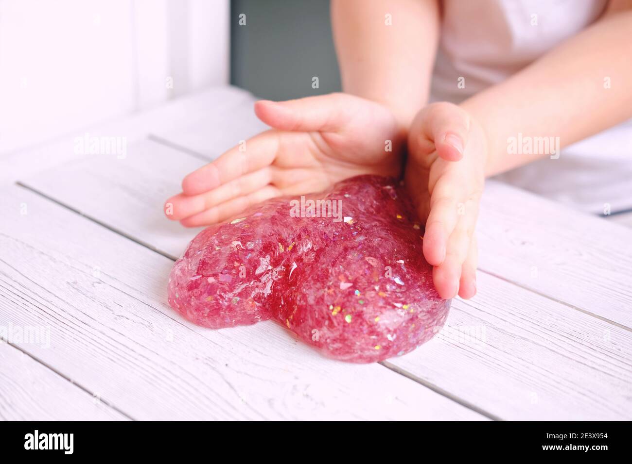 little girl holding a heart shaped slime. symbol of support, care ...