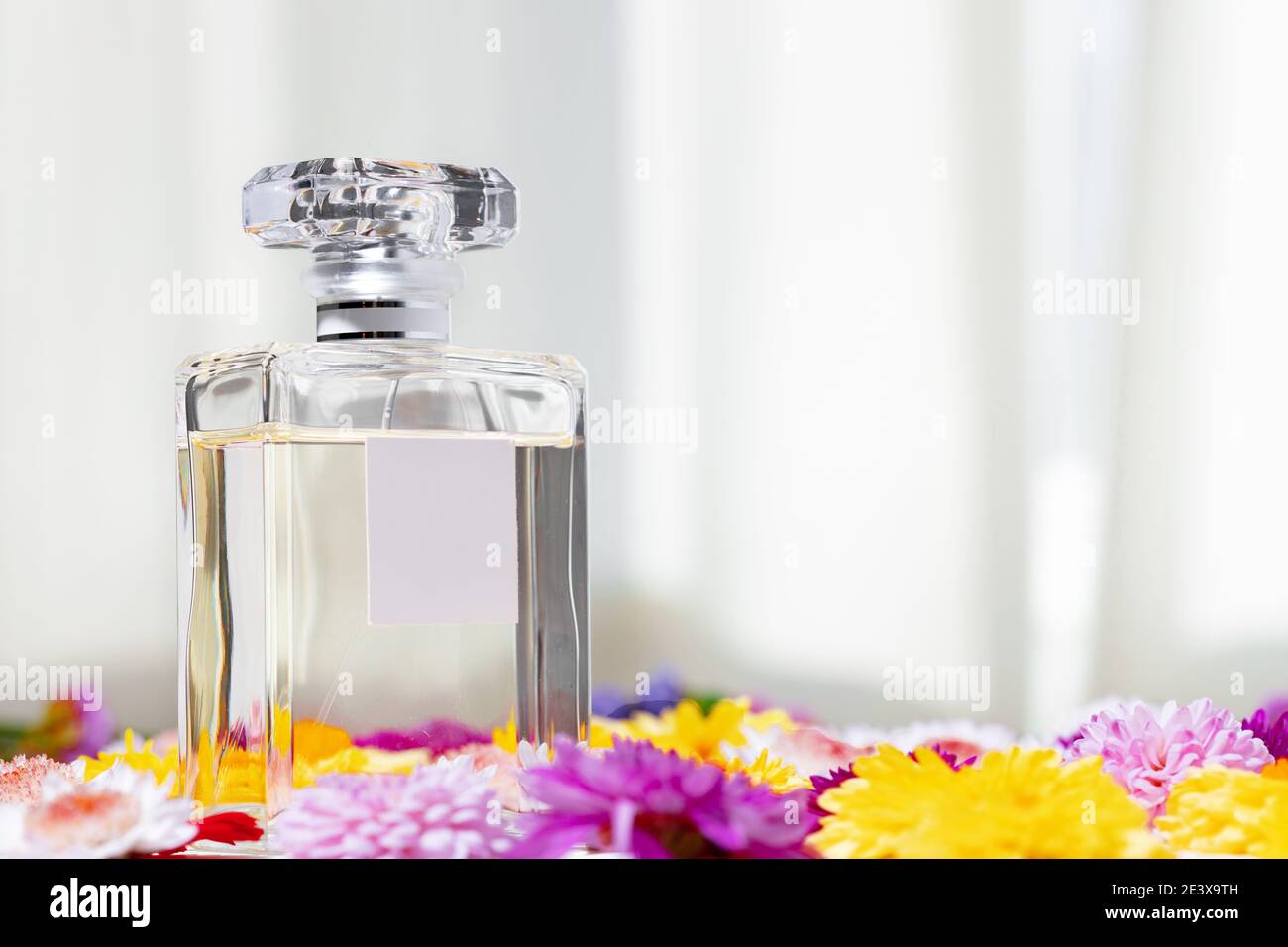 Perfume bottle for women in flower buds Stock Photo - Alamy