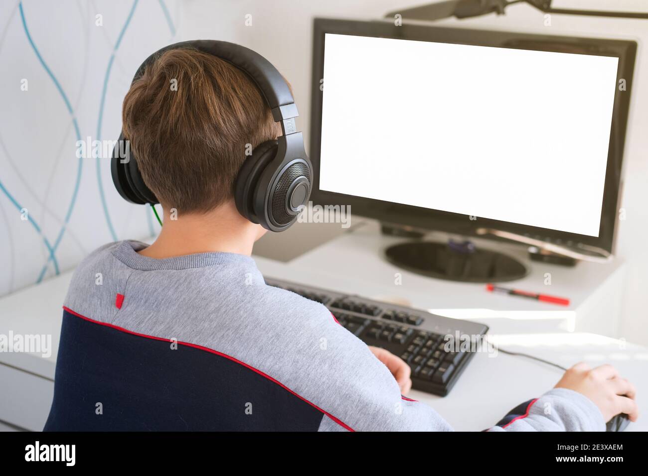 teenager boy looking at computer monitor. computer screen mockup. happy ...