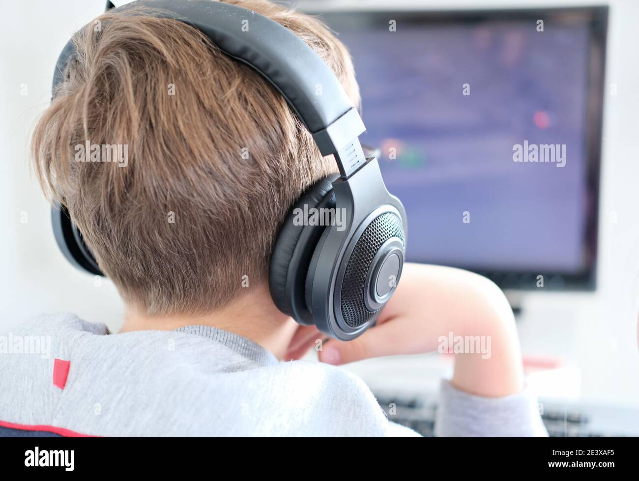 teenager boy looking at computer monitor. focus on a boy. happy smiling ...