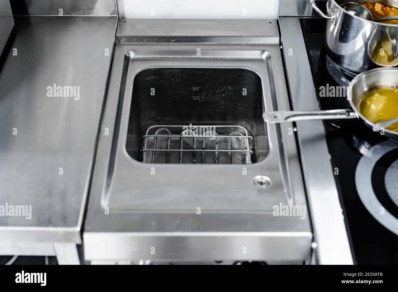Stainless steel deep fryer machine in professional kitchen Stock Photo ...
