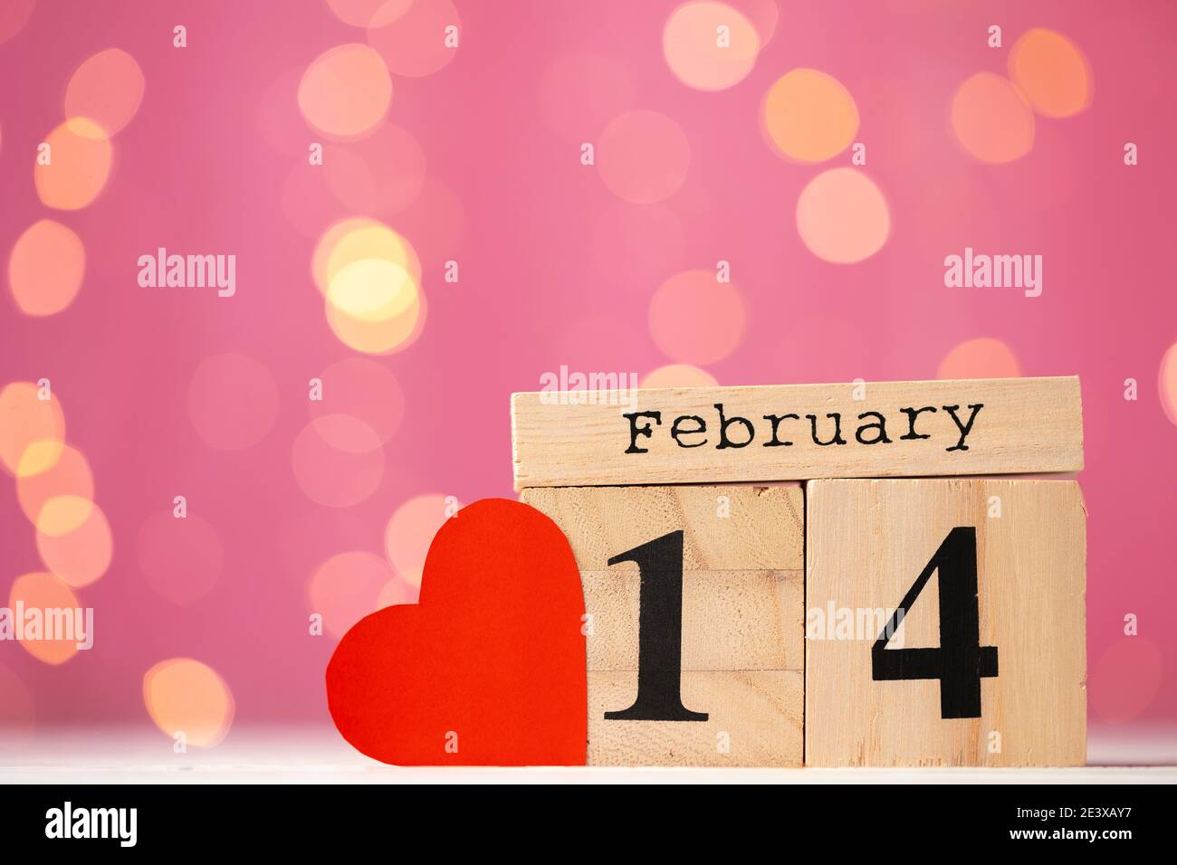 Wooden calendar 14th of February on pink bokeh background Stock Photo ...