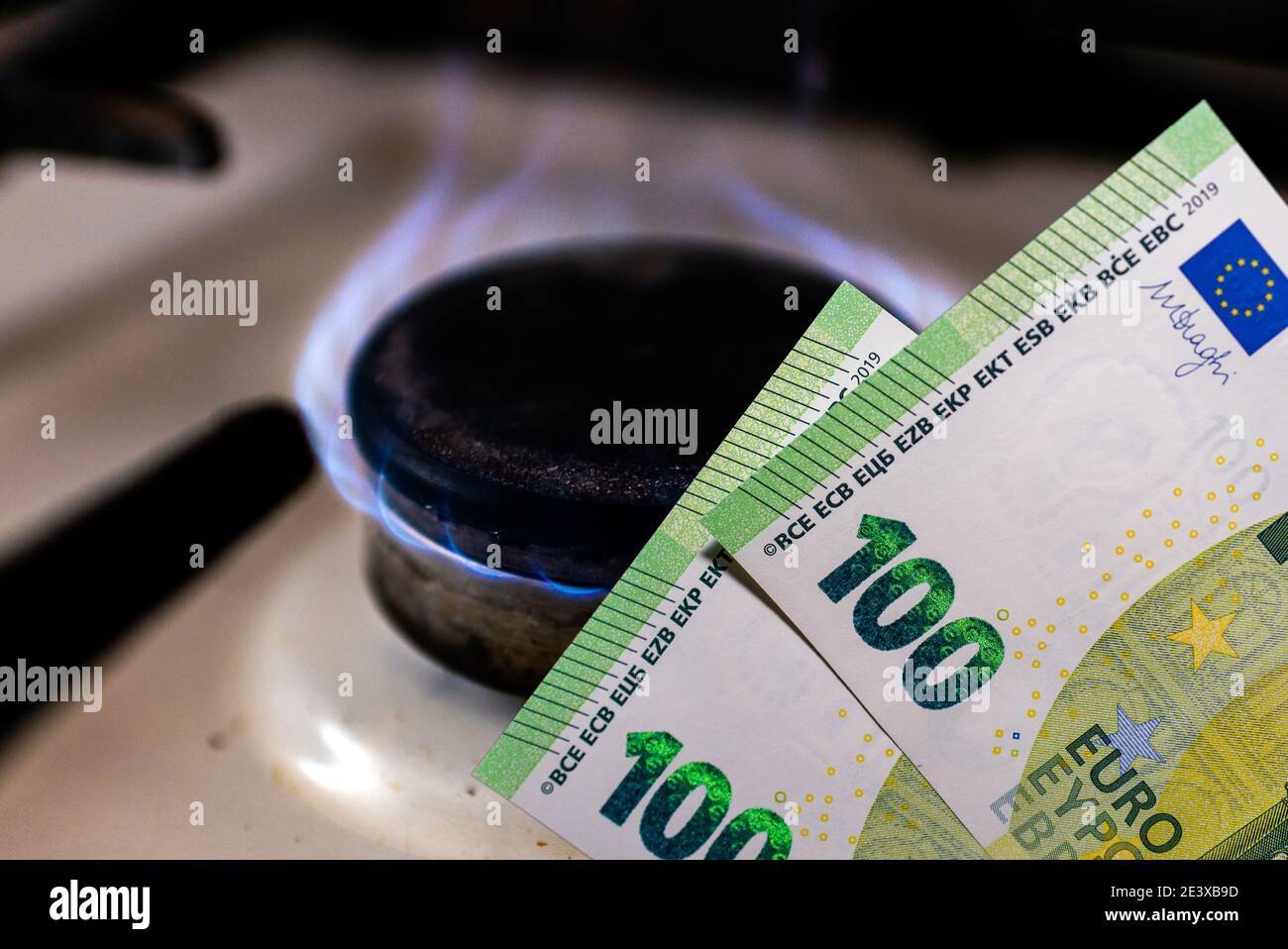 Money and stove.Burning stove flame and one hundred bills two ...