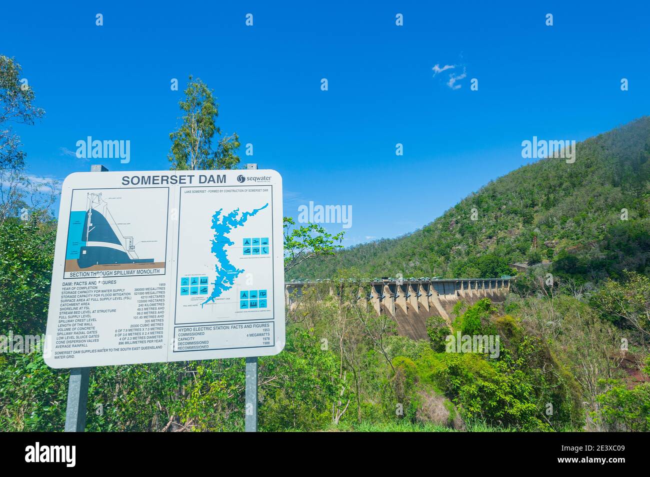 Information sign at the Somerset Dam with the dam wall across the ...