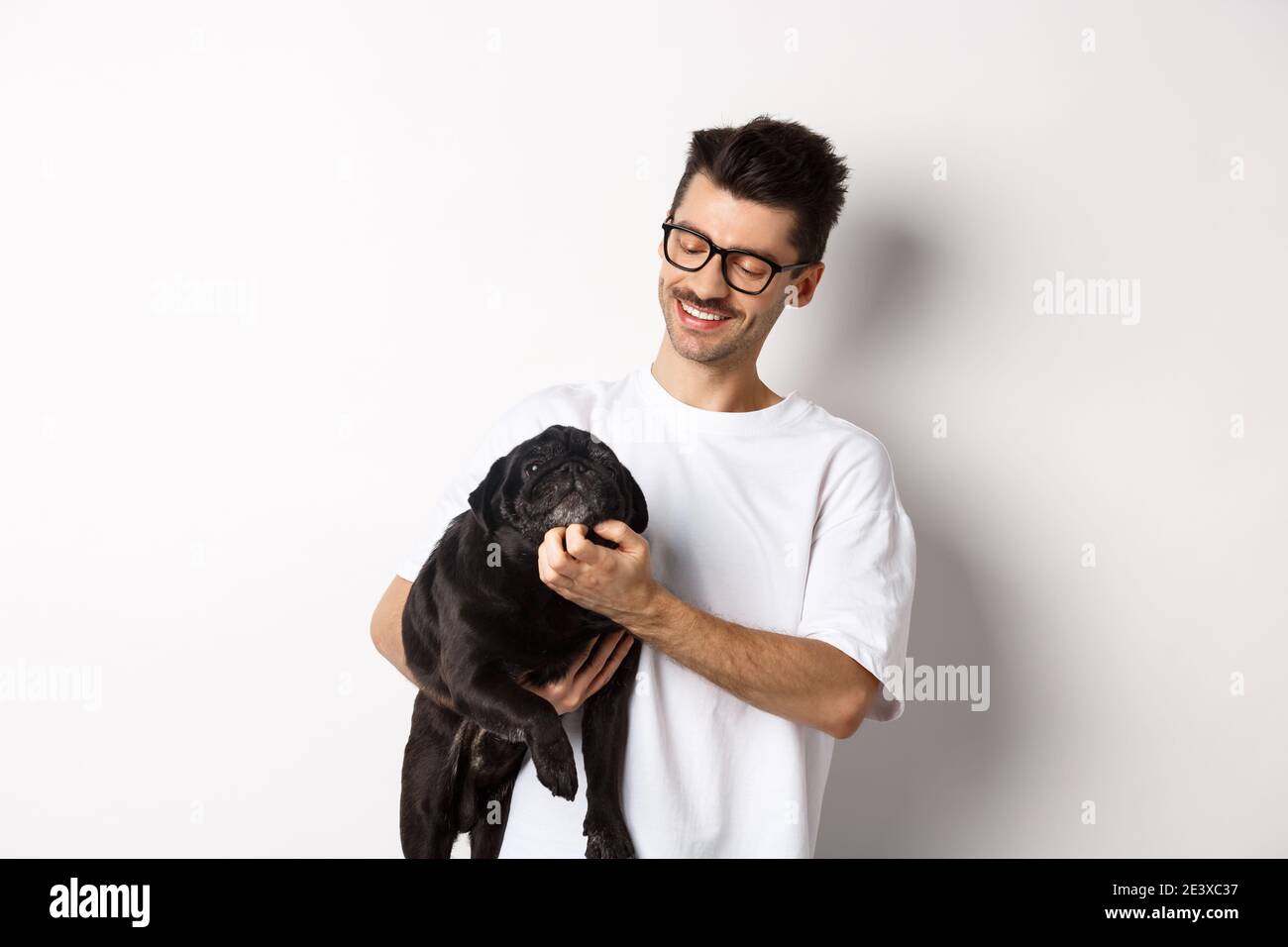 Happy young man scratching dog hi-res stock photography and images - Alamy