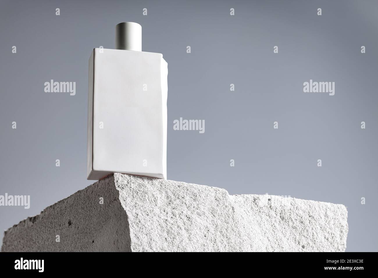 Bottle of perfume on cinder block close up Stock Photo - Alamy