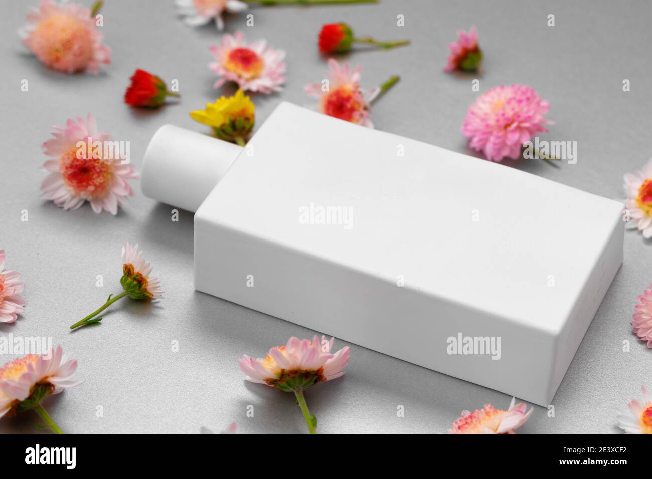 Bottle of fragrance surrounded by flower buds Stock Photo - Alamy