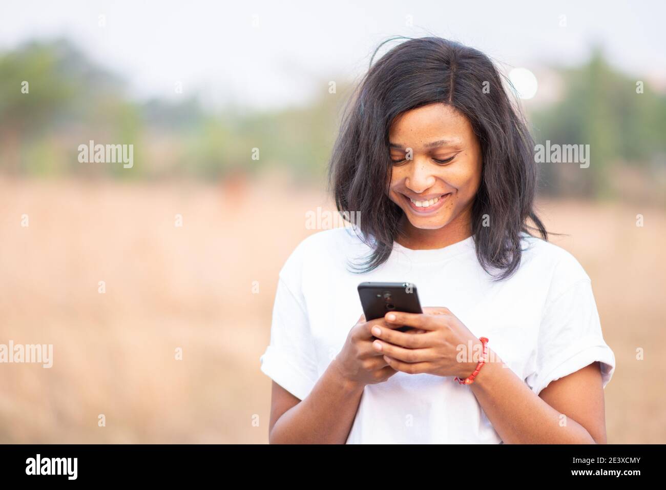 beautiful light skin african lady with freckles smiling while using her ...