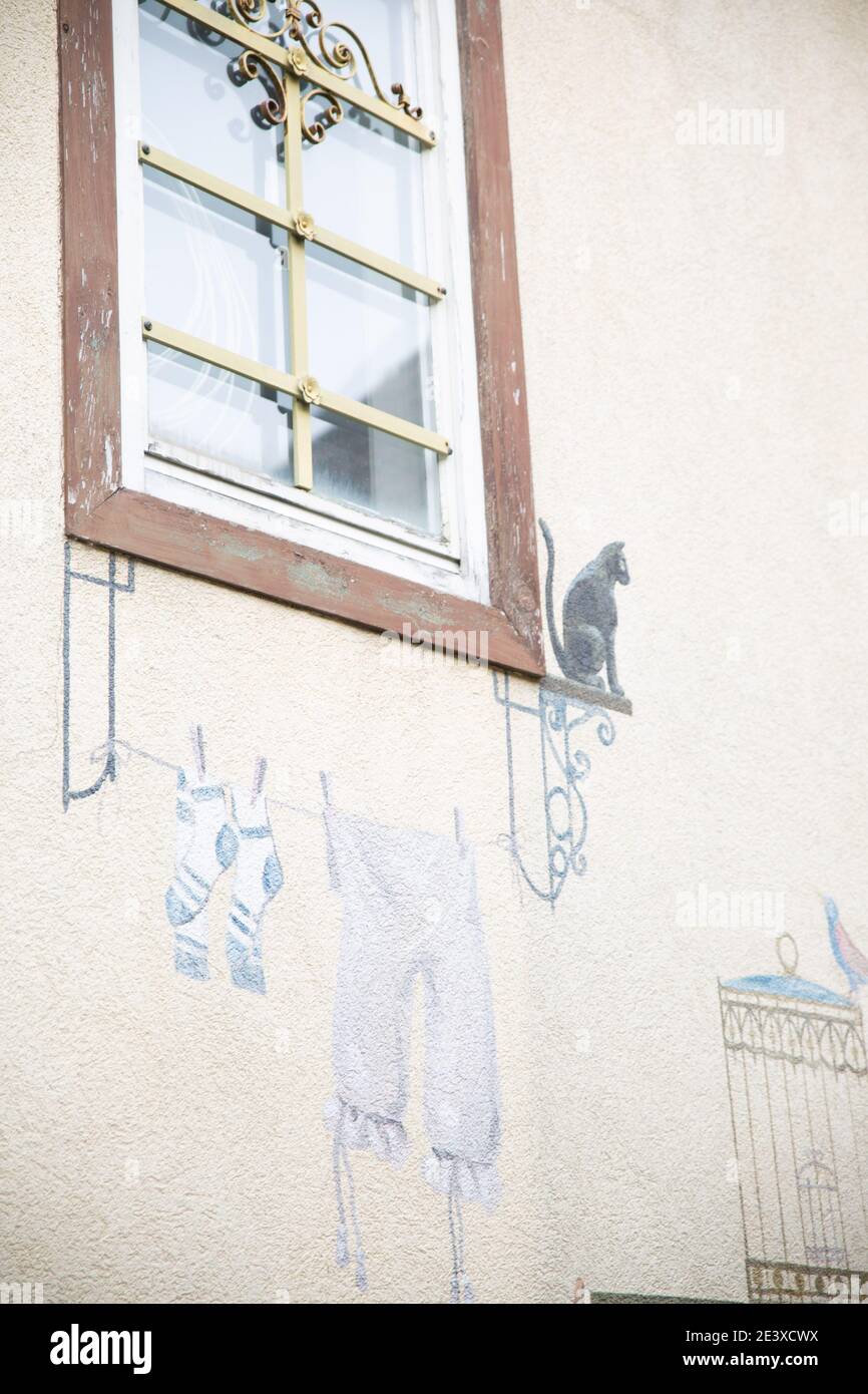 Painted facade with real window Stock Photo - Alamy
