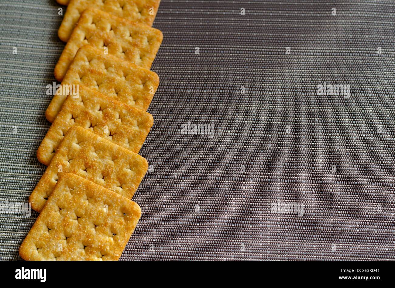 Groceries, snacks, food. Salted crispy crackers on a gray textured ...