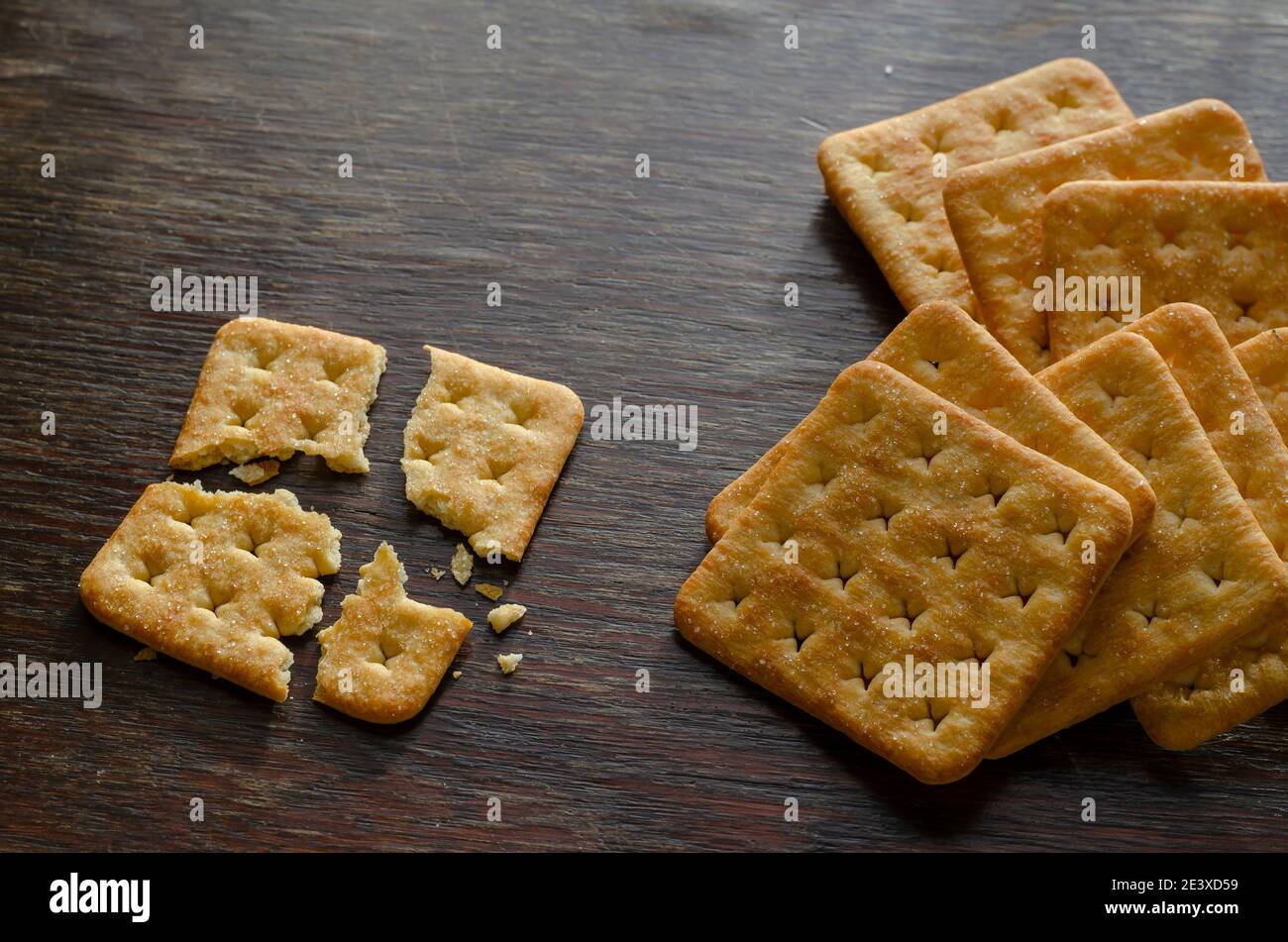 Groceries, snacks, food. Stack of Salted Crunchy Crackers on a wooden ...