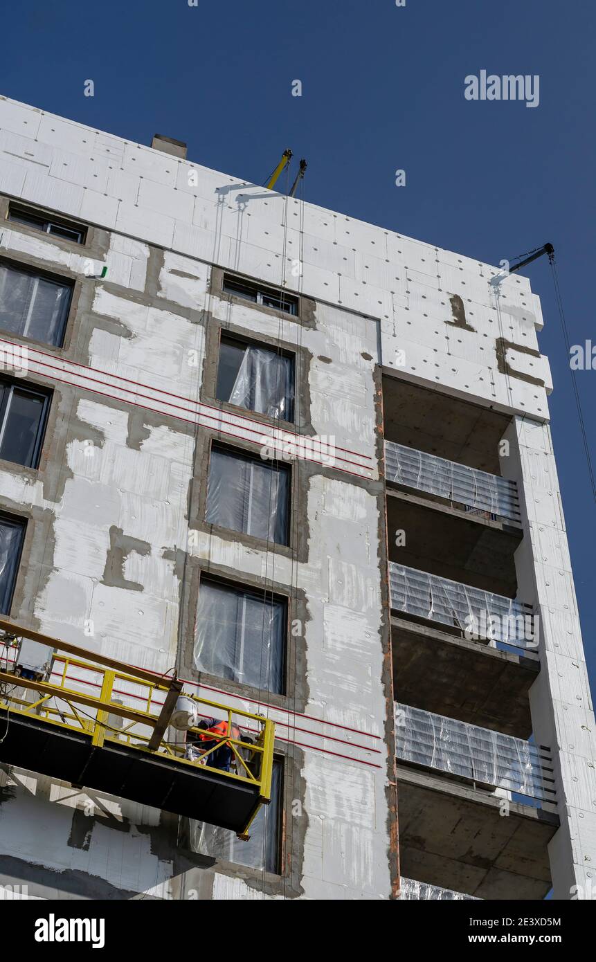 Thermal insulation of the walls of a new unfinished apartment building ...