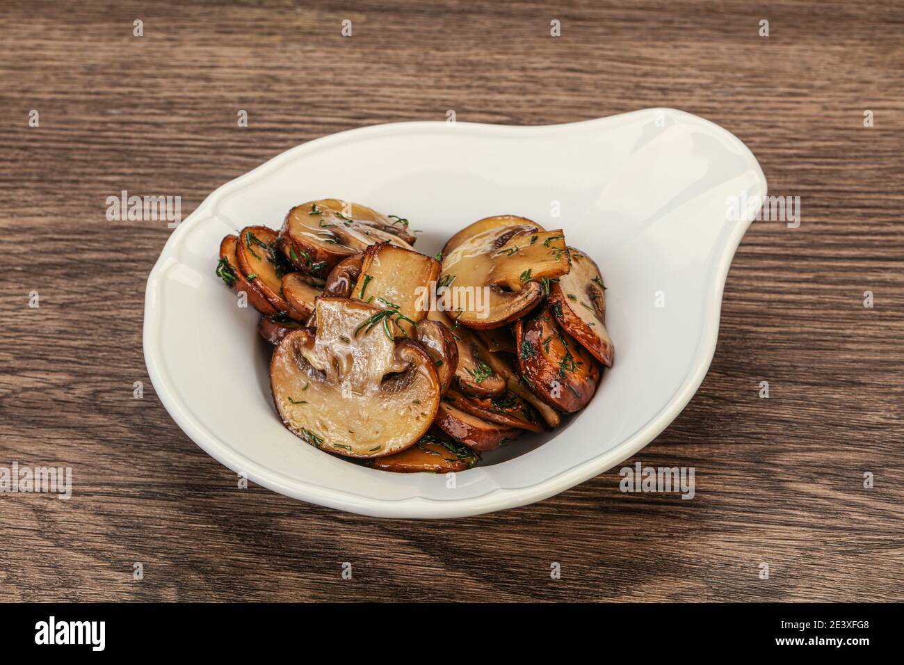 Roasted champignon with herbs and spices in the bowl Stock Photo - Alamy