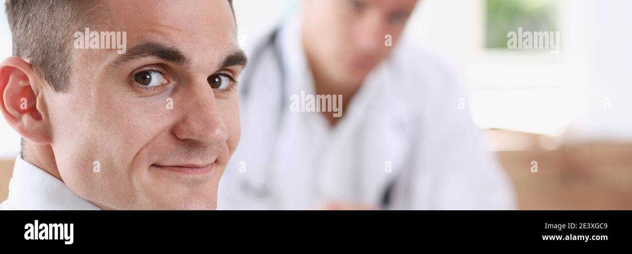 Satisfied happy handsome smiling male patient with doctor Stock Photo ...