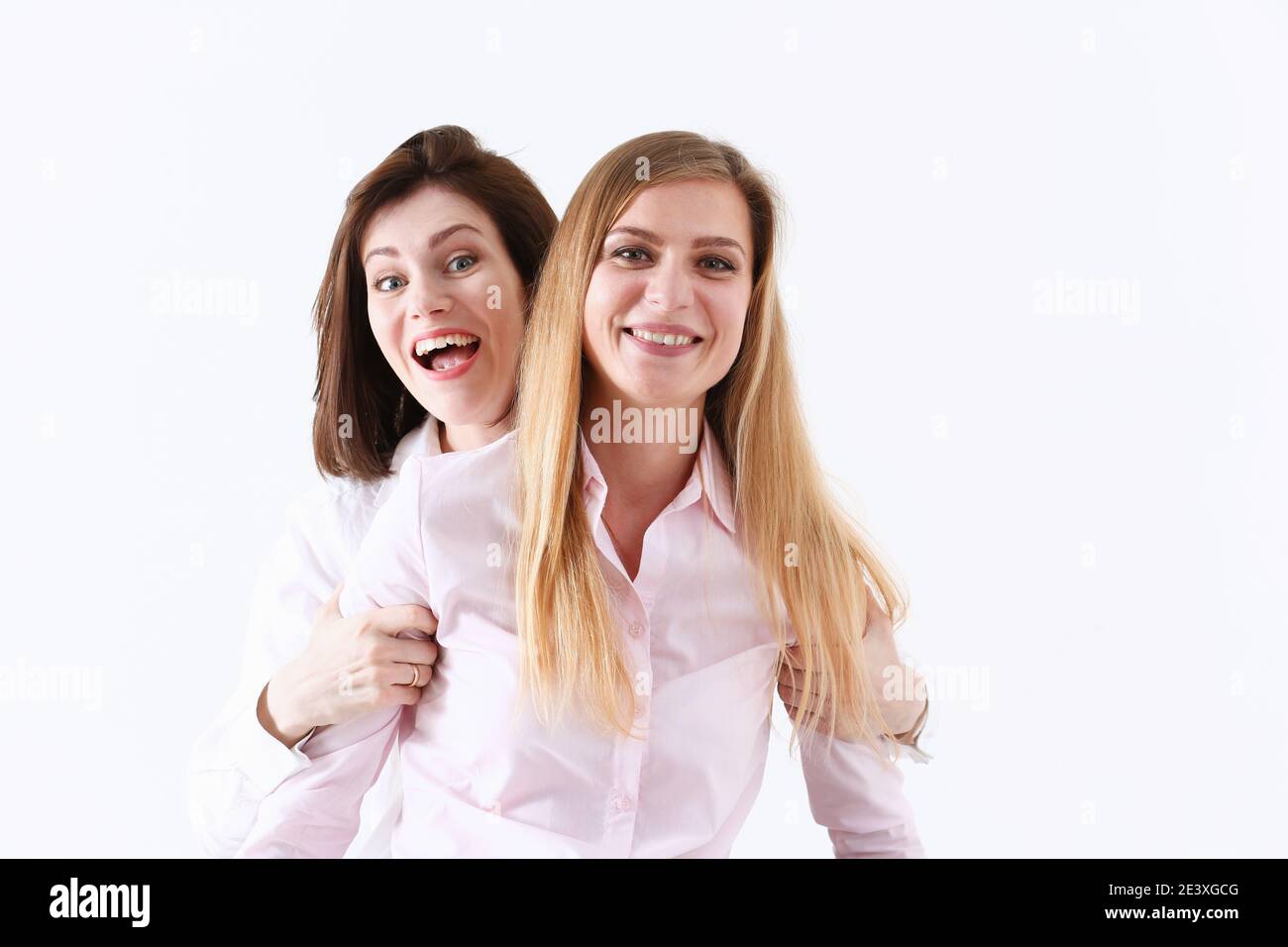 Two smiling happy joyful female friends portrait Stock Photo - Alamy