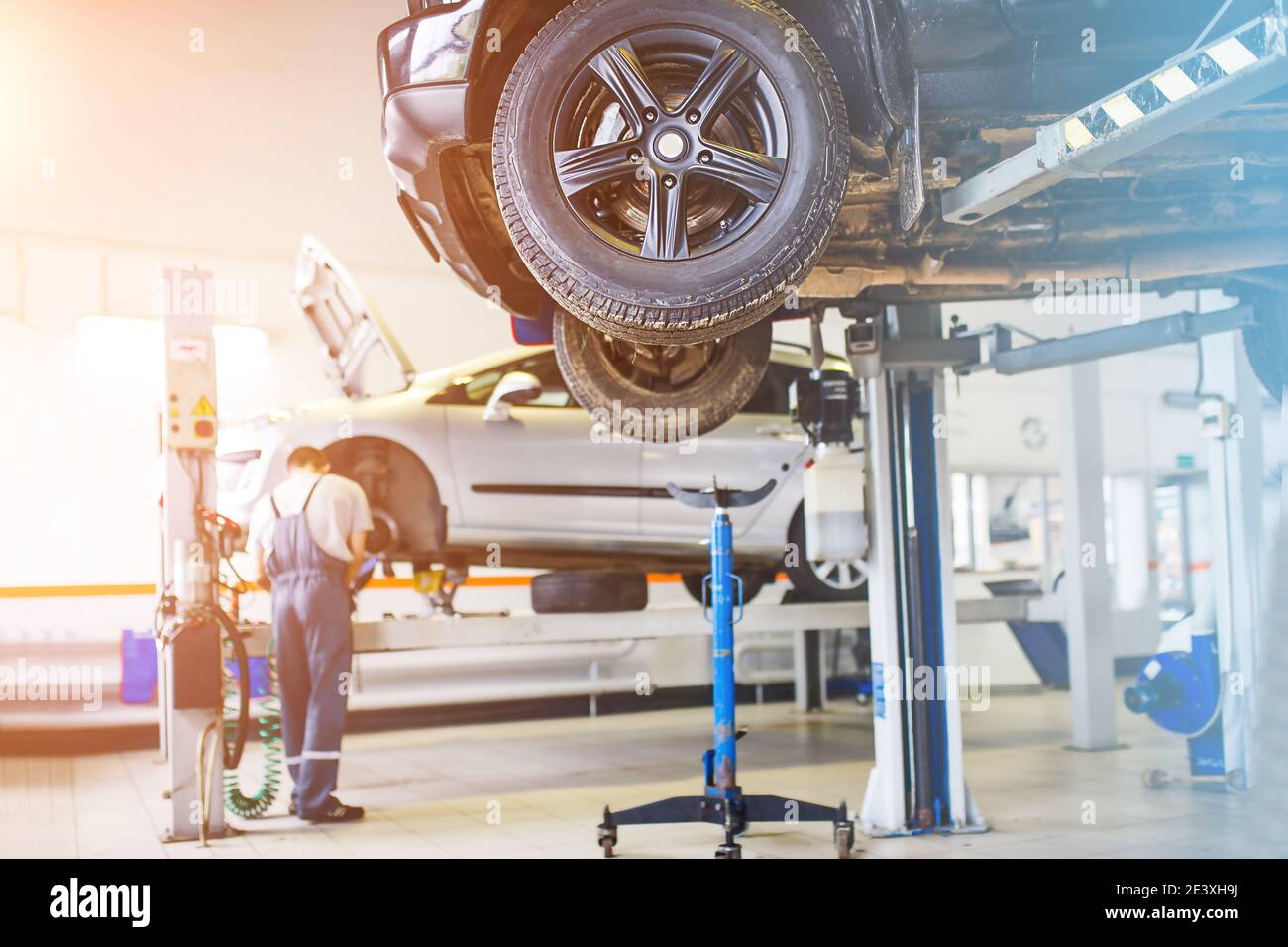 Car lifted up in service station hi-res stock photography and images ...