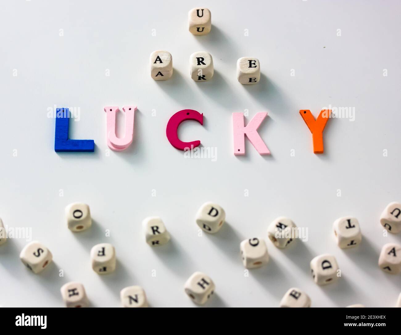 You are lucky colorful words written on wood blocks, white table abc ...