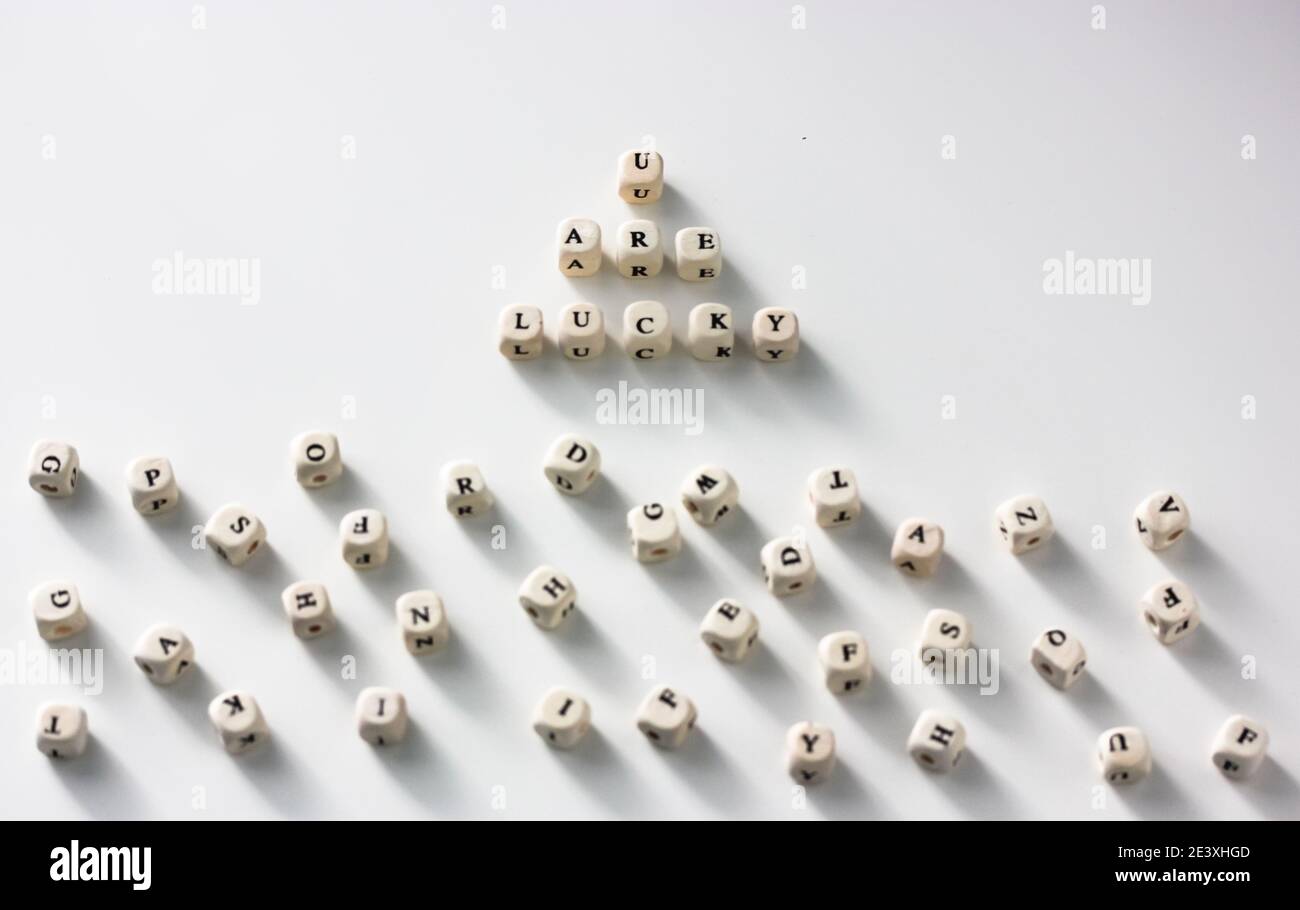 You are lucky words written on wood blocks, white table, black and ...