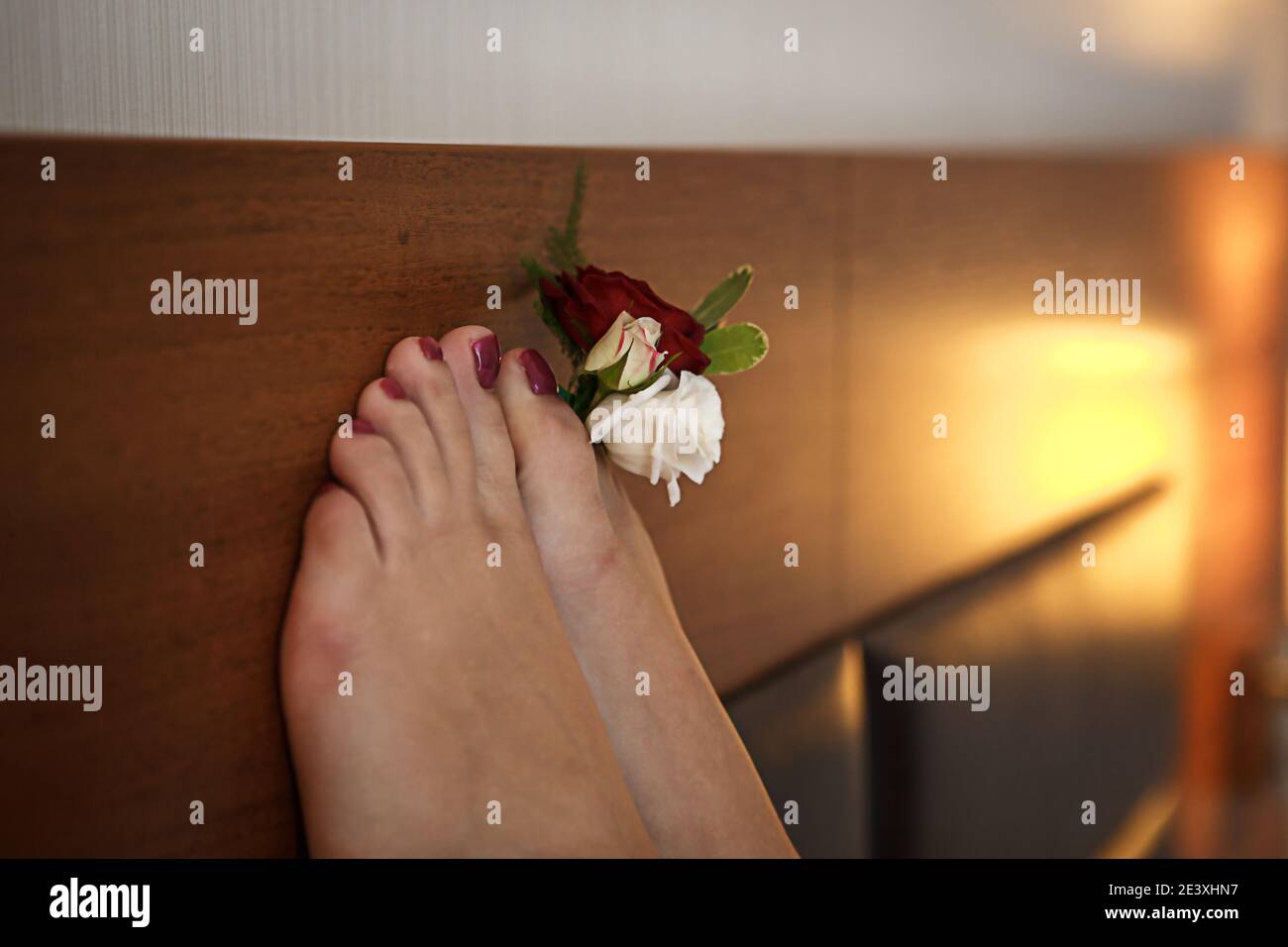The groom's boutonniere of red and white roses in the toes with a red ...