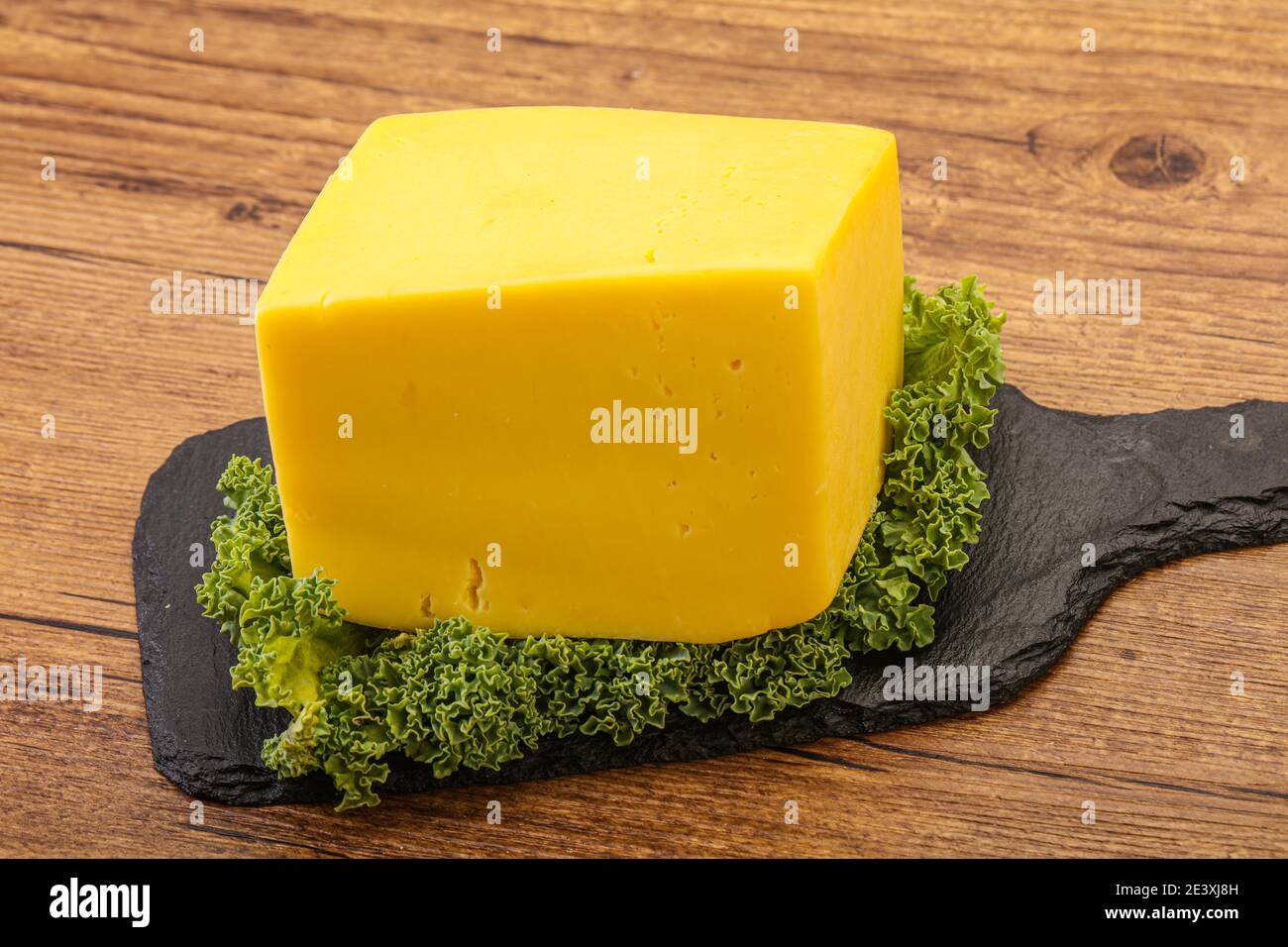 Yellow tilsiter cheese dairy product brick Stock Photo - Alamy