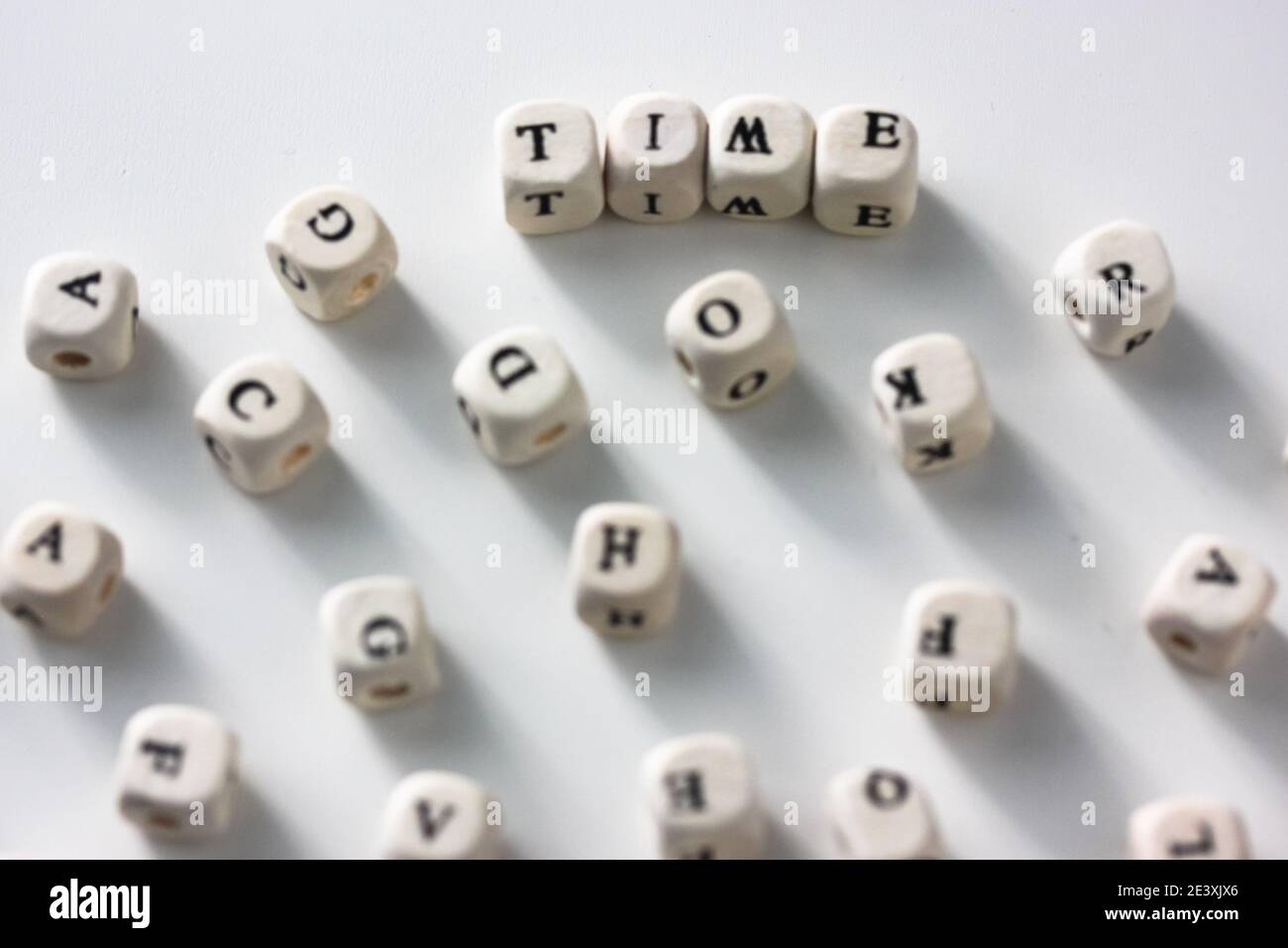 Time - the words written on wood blocks, white table, black and white ...