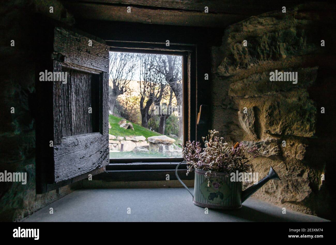 Interior view from the window of a rustic house towards a beautiful ...