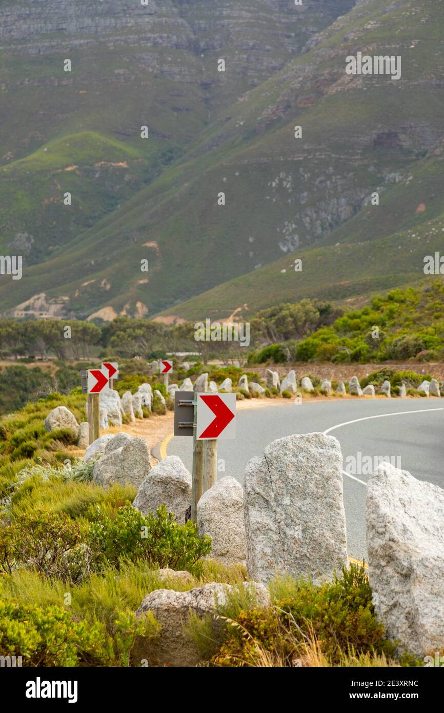 Chevron warning road sign for sharp hairpin bend on mountain pass in ...