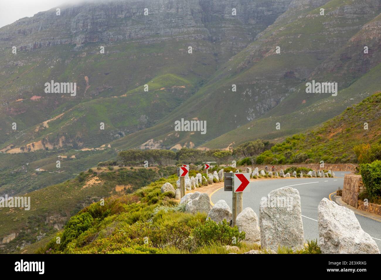 Chevron warning road sign for sharp hairpin bend on mountain pass in ...