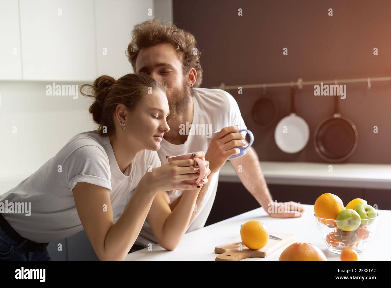 Morning coffee and gentle kissing feeding each other making fun at ...