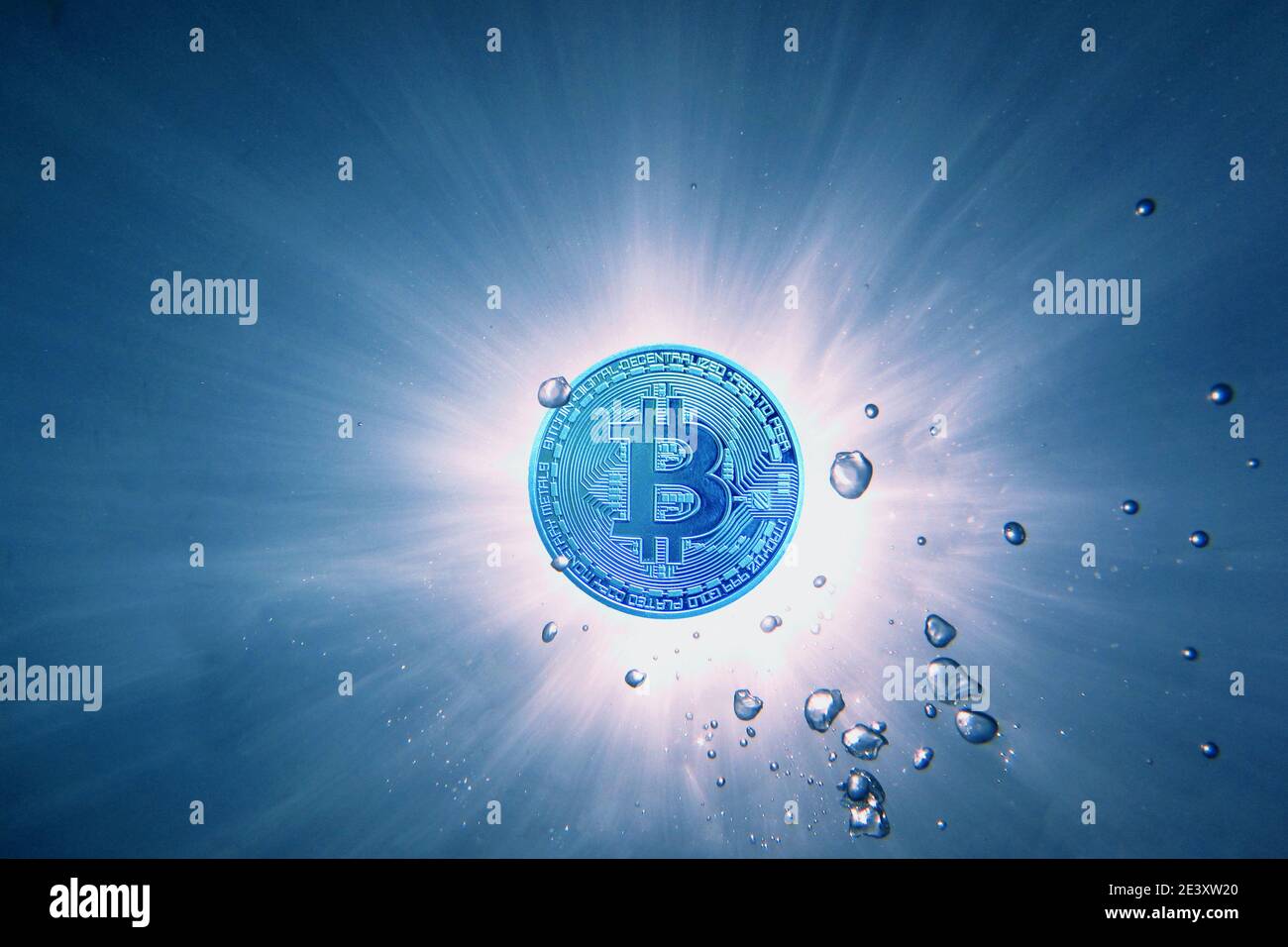 blue bitcoin instead a sun with sun rays view from underwater with ...