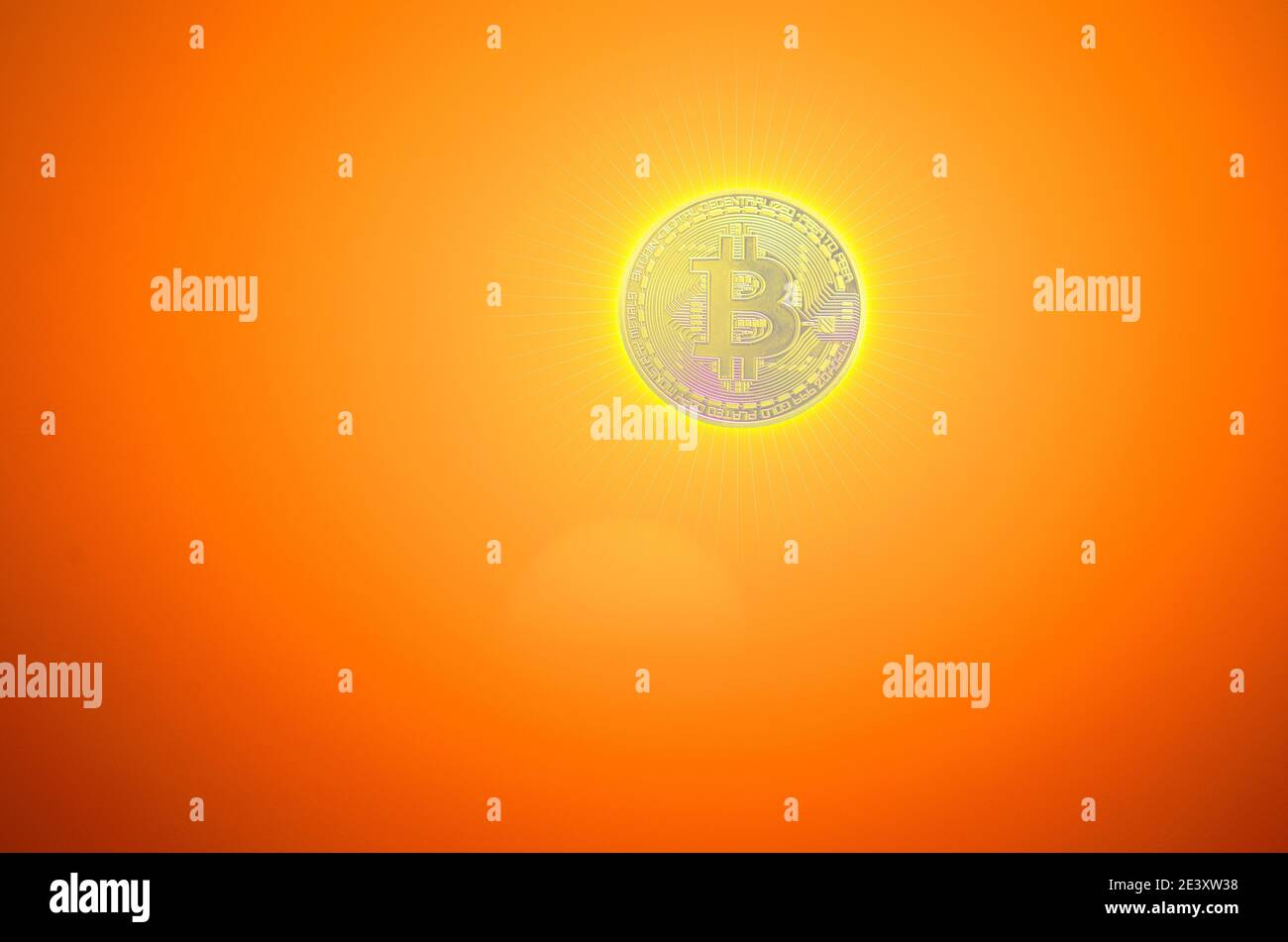 burning bitcoin instead a bright sun with little artifical sun rays on ...