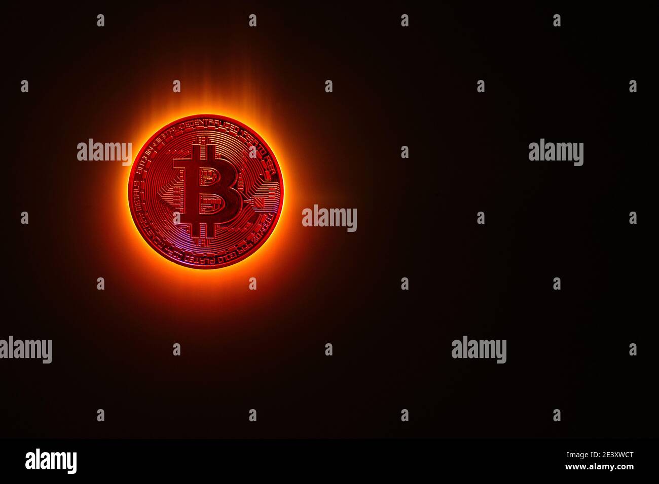 red glowing bitcoin instead a burning sun with black background Stock ...