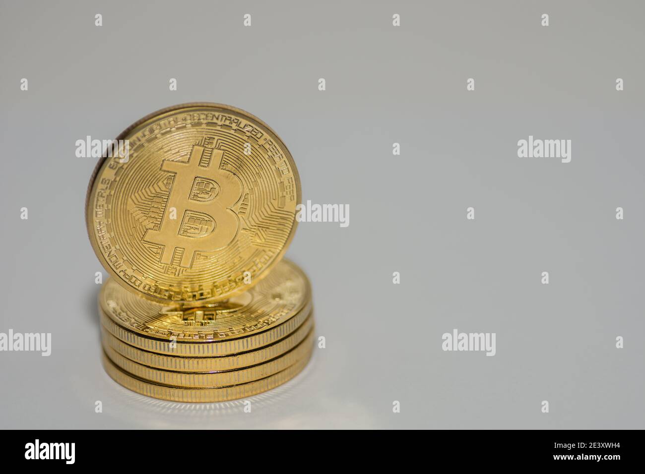 one bitcoin stands on the top of other bitcoins that are stacked with ...