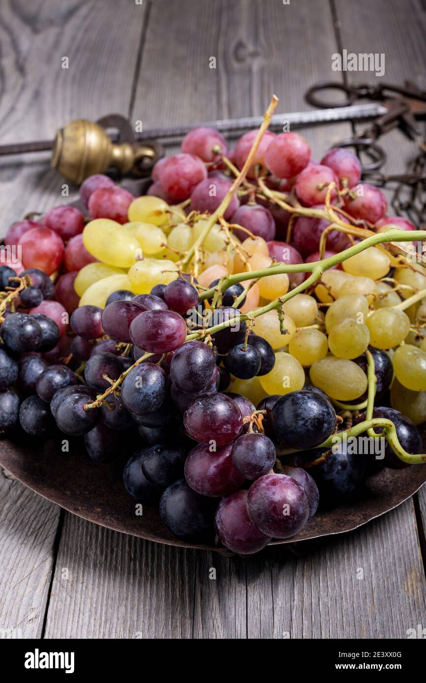 on a rustic wooden surface, an old steelyard, with various types of ...