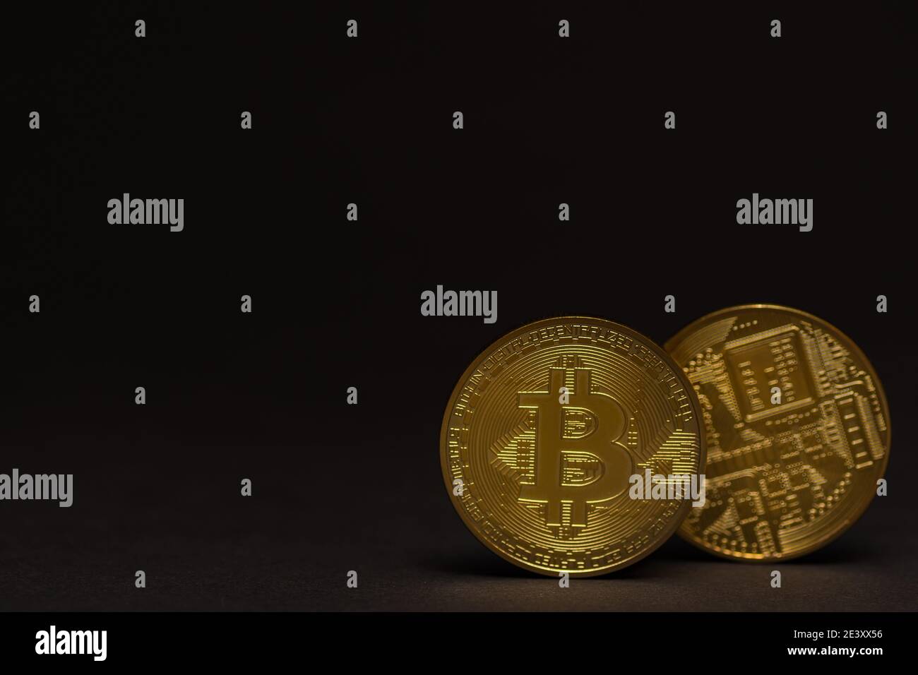two golden shiny valuable bitcoin with front and back side with black ...