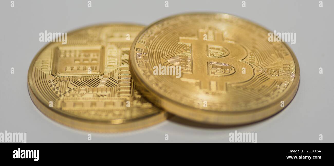 two lying bitcoins with front and back side view on gray panorama view ...
