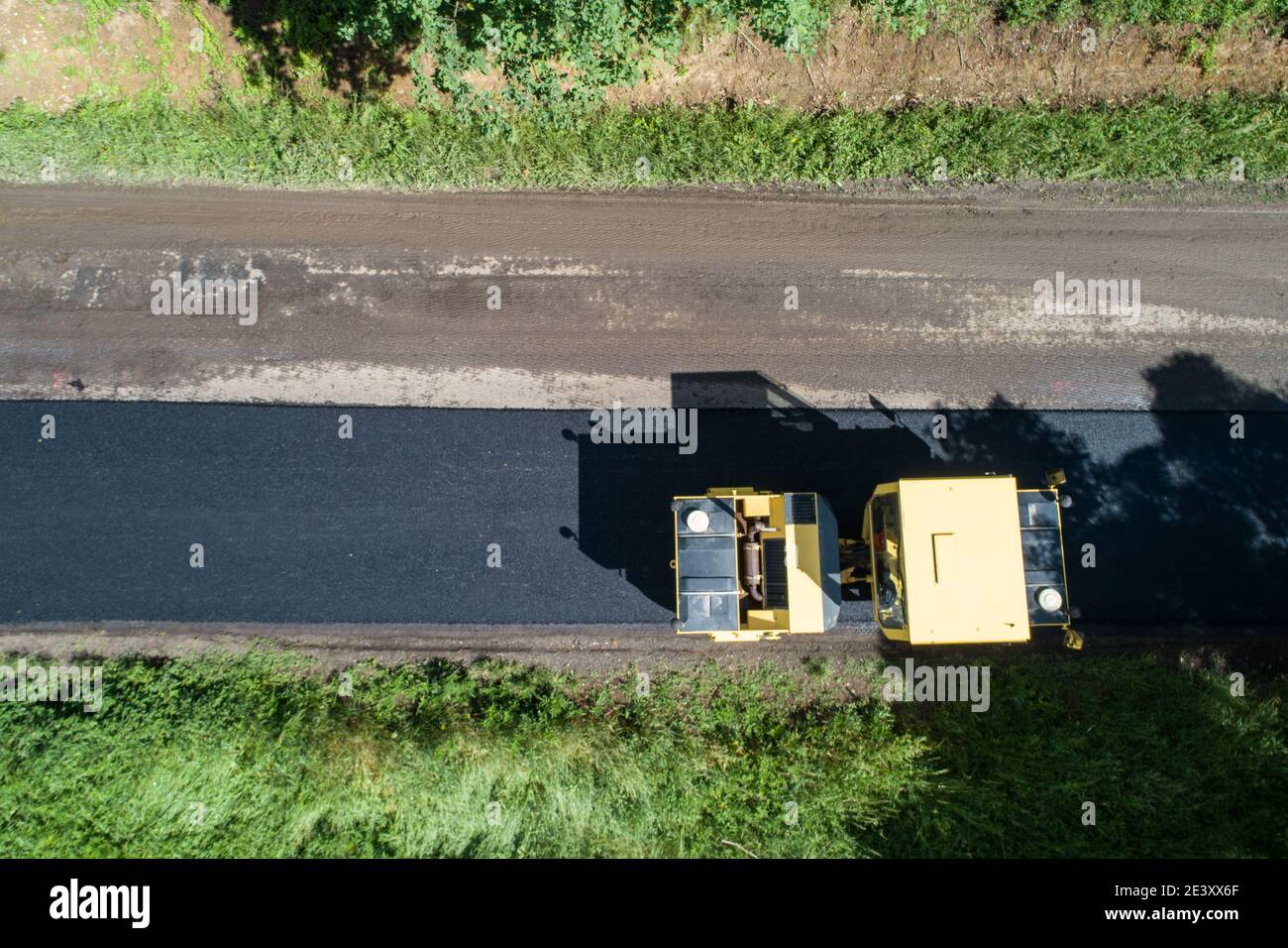 Aerial photo of road roller machine rolls asphalt Stock Photo - Alamy