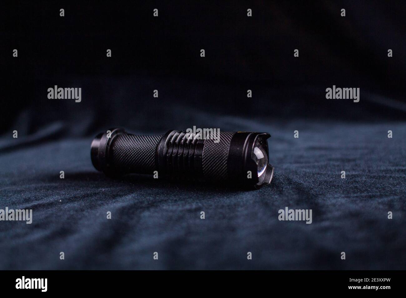 a tactical flashlight on black background shines Stock Photo - Alamy