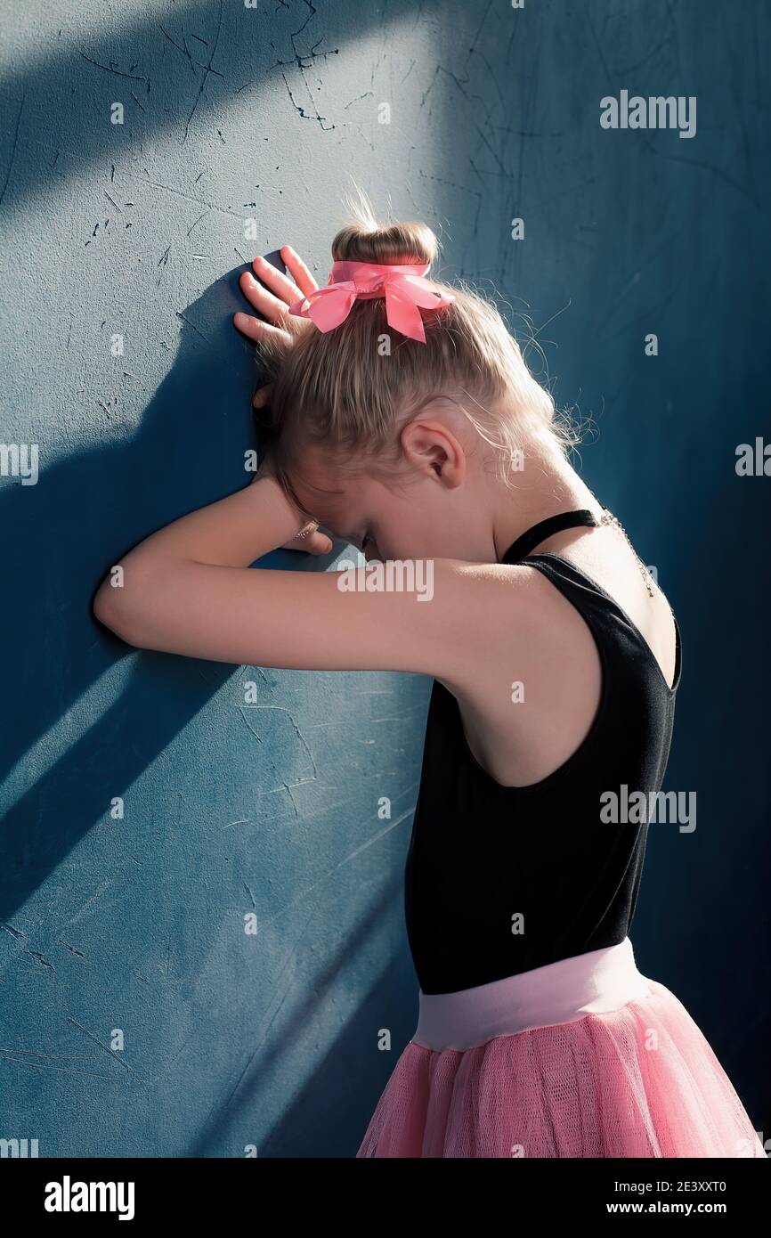 Young ballerina crying in despair due to failures in the classroom at ...