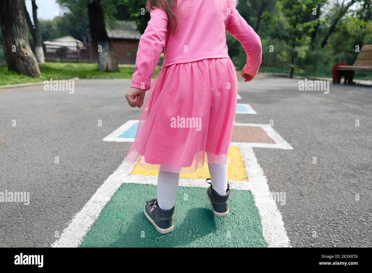 Young cute girl playing hopscotch on backyard Stock Photo - Alamy