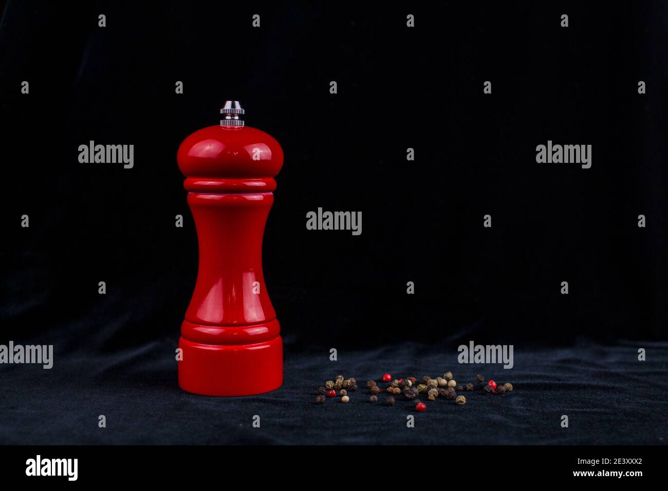 a red pepper shaker on black background in the kitchen Stock Photo - Alamy
