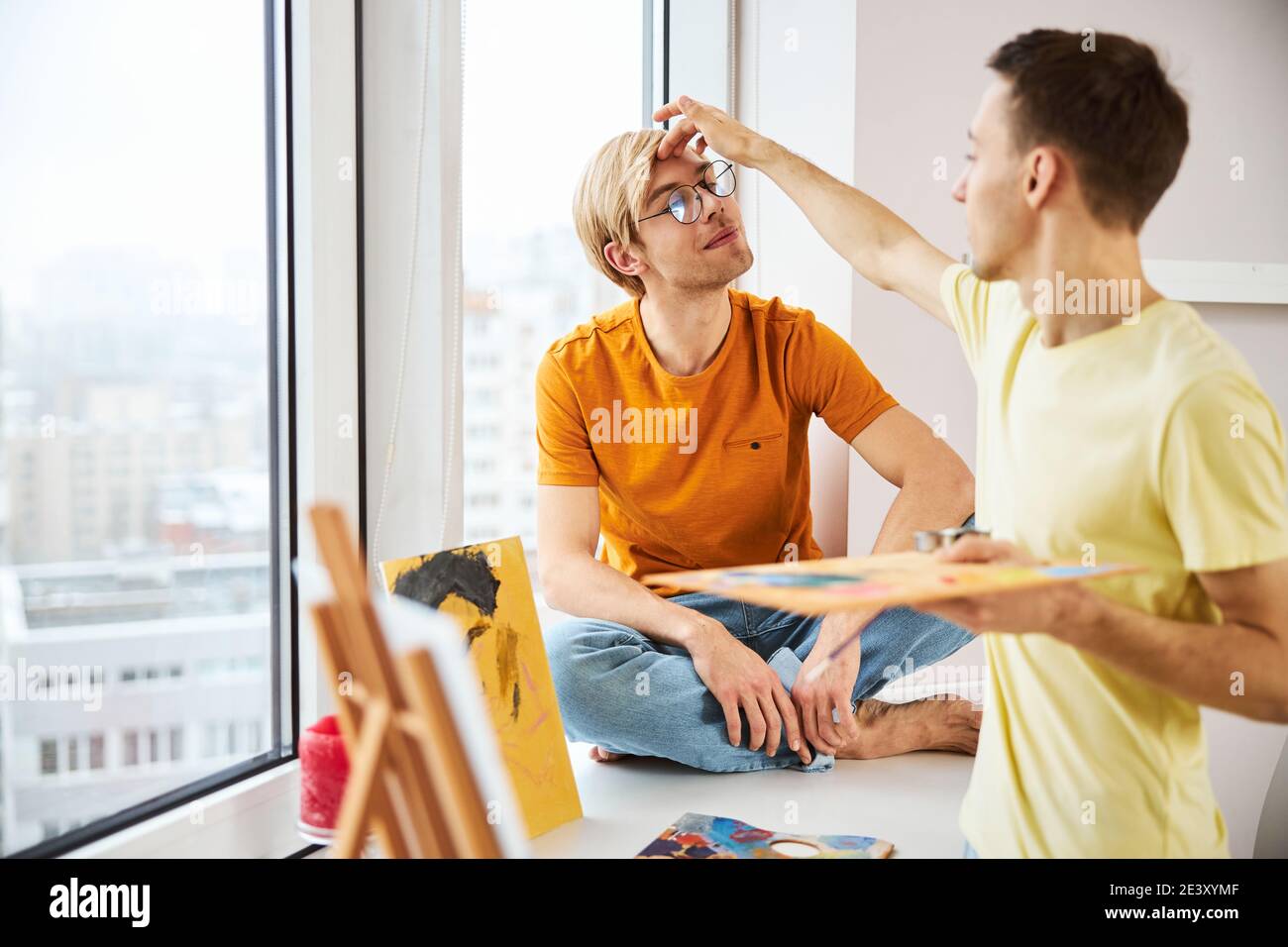 Handsome male artist spending time with boyfriend at home Stock Photo ...