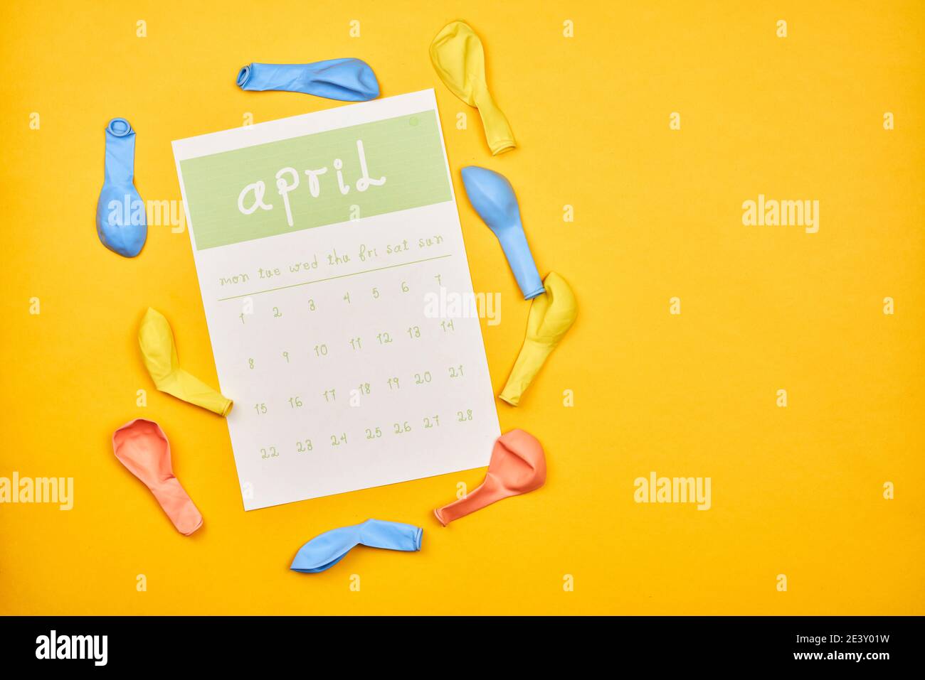 April calendar with copy space on yellow background Stock Photo - Alamy