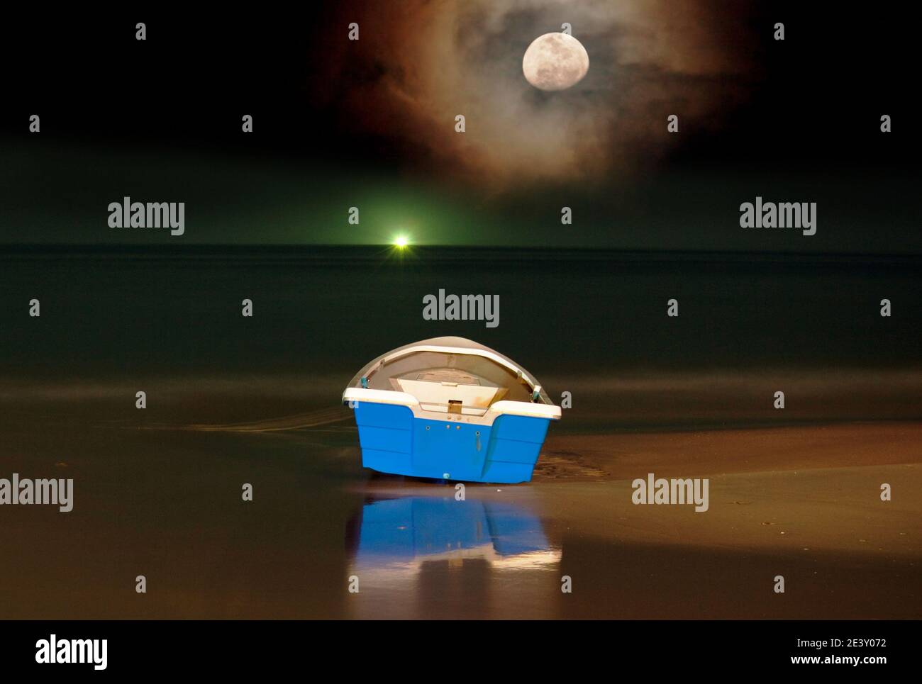 Full moon rising above ocean coast Stock Photo - Alamy