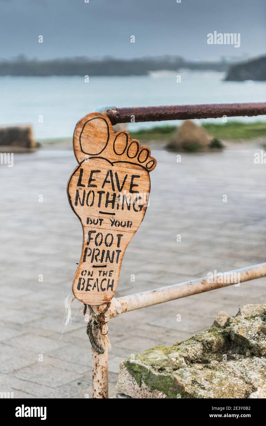 A handmade wooden sign requesting you to leave nothing but your ...