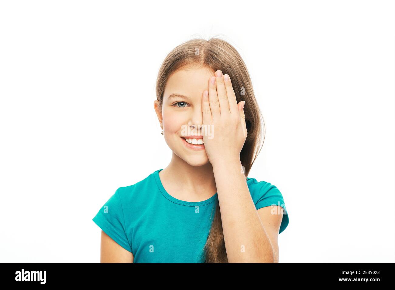 Smiling child closing eye with her hand for checking vision, isolated ...