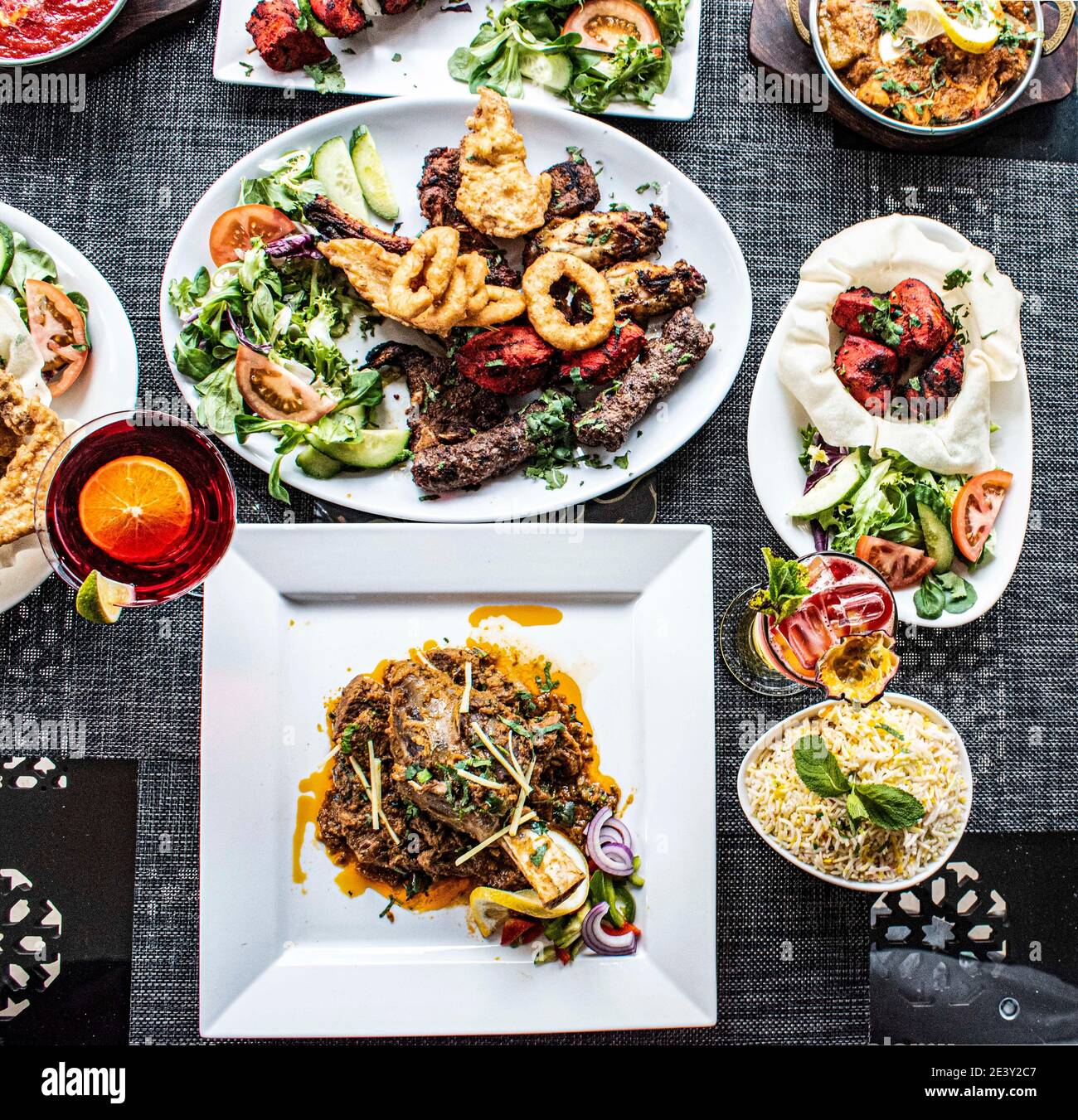 Indian cuisine food platter curry rice kebabs salad Stock Photo - Alamy