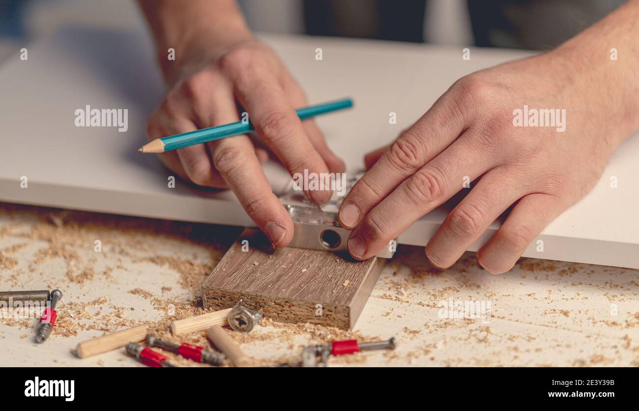 Man working during process of furniture manufacturing Stock Photo - Alamy