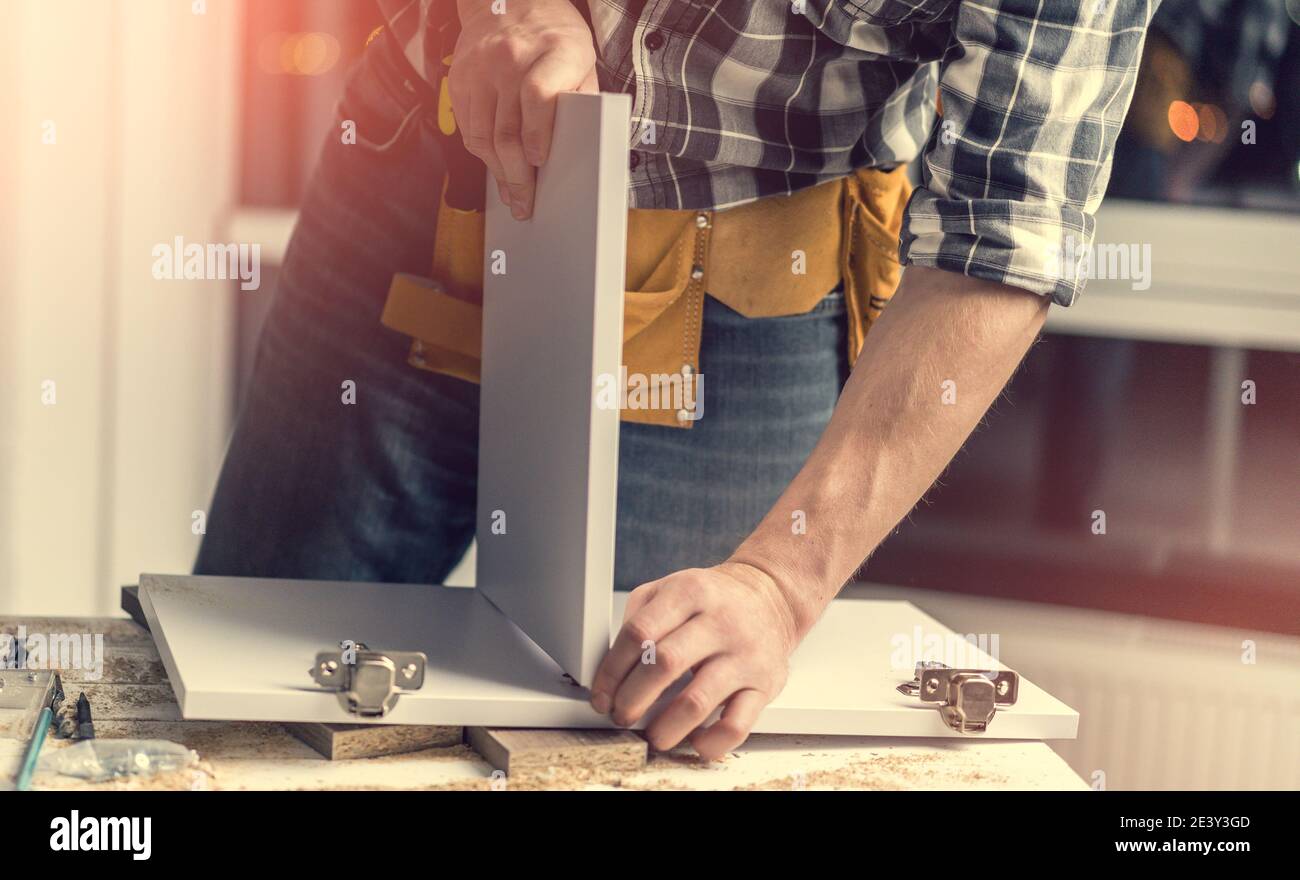 Man working during process of furniture manufacturing Stock Photo - Alamy